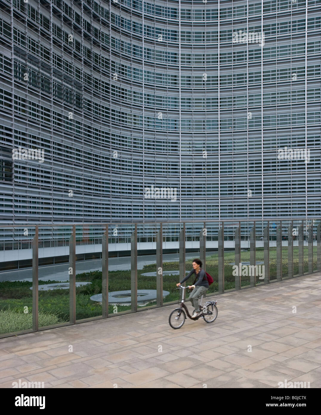woman riding bicycle past berlaymont building Stock Photo - Alamy