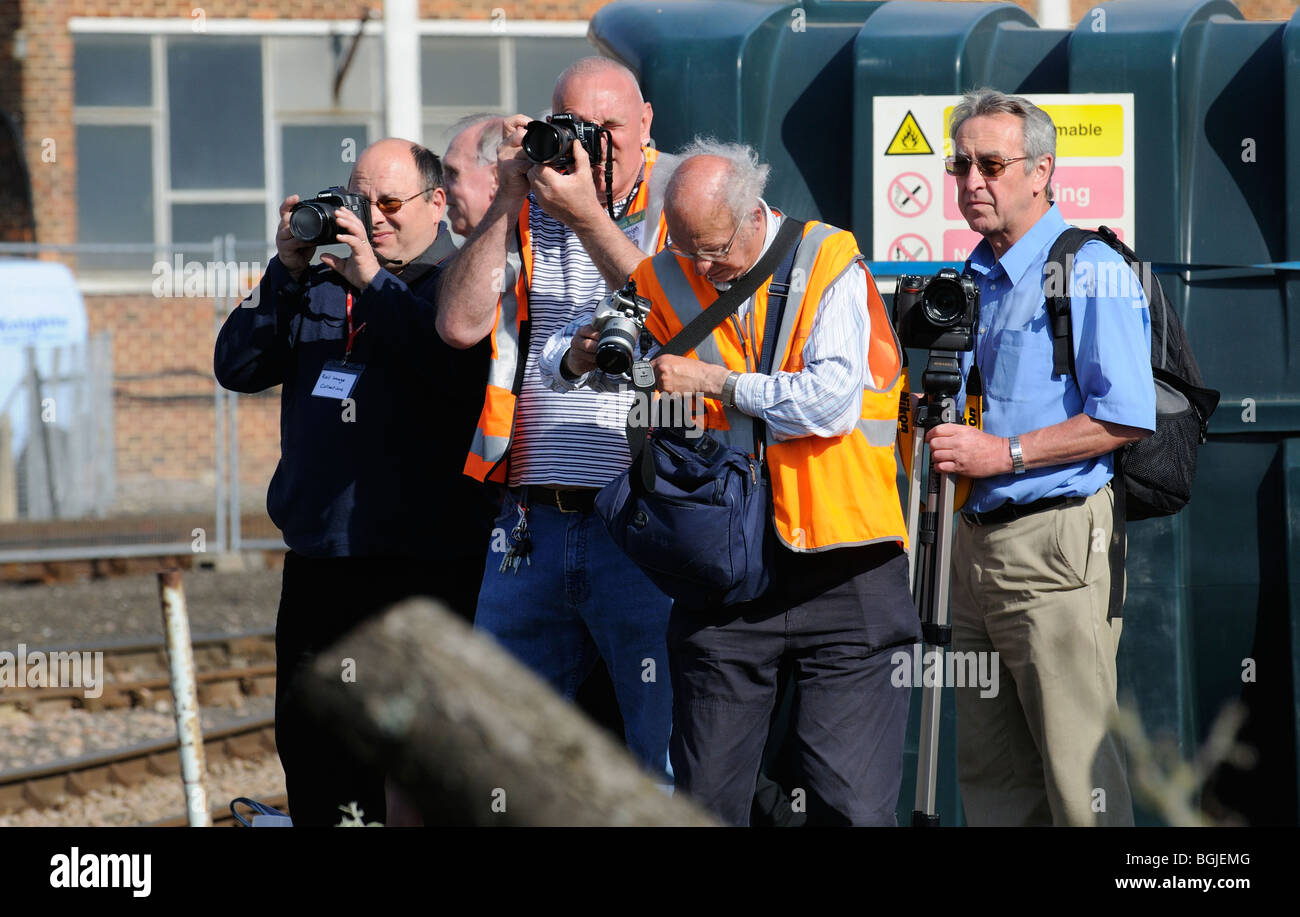 Group of railway train enthusiasts and photographers taking pictures at ...