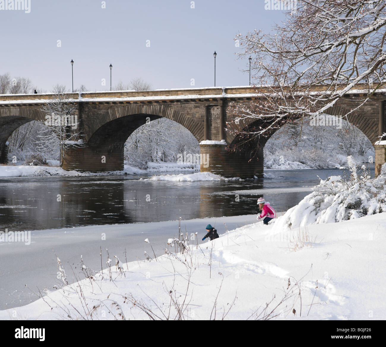 Kelso Scotland in winter snow - children playing near the old bridge ...