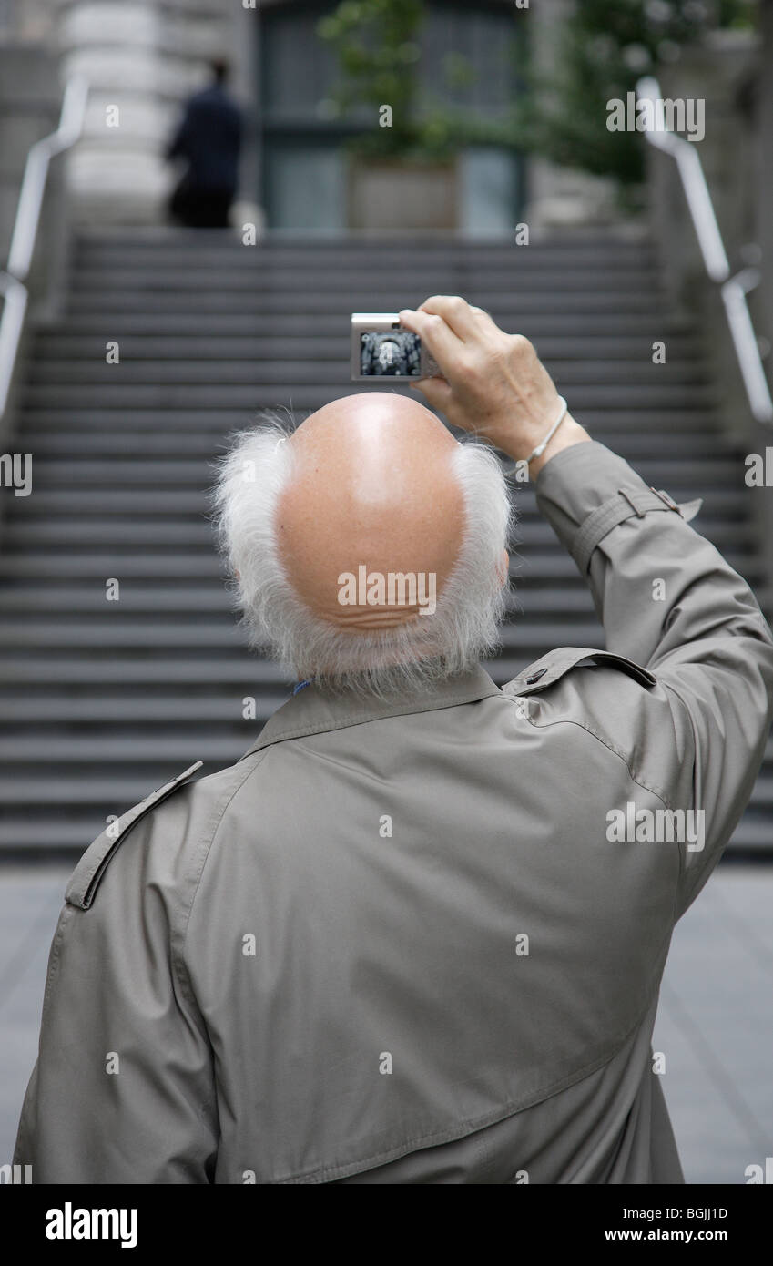 elderly man with bald patch taking photo Stock Photo - Alamy