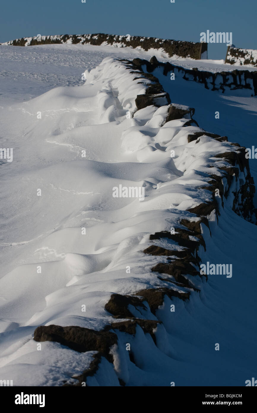 Snow drifted against dry stone walls Stock Photo - Alamy