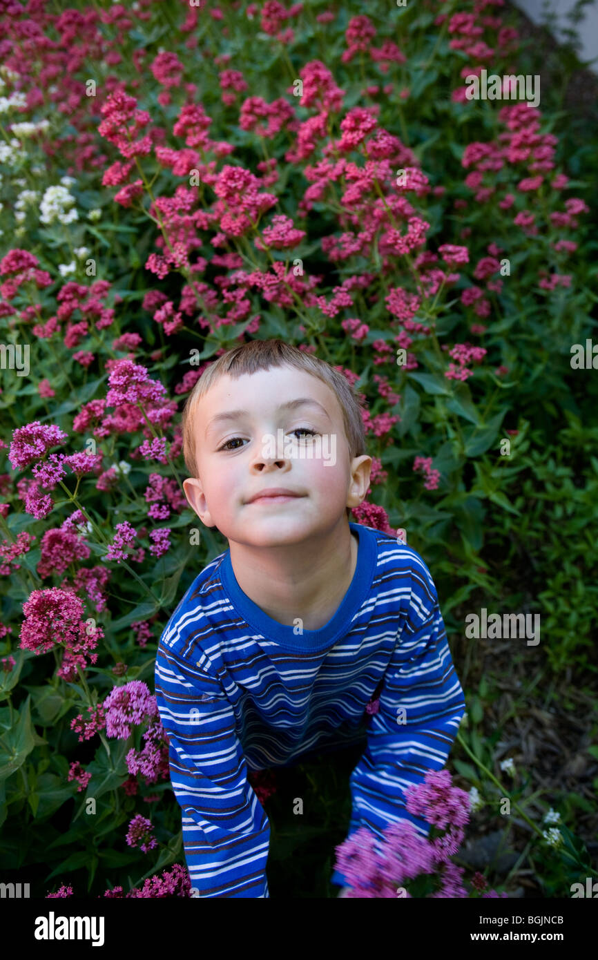 A young boy wearing a backpack ready for his school day Stock Photo - Alamy