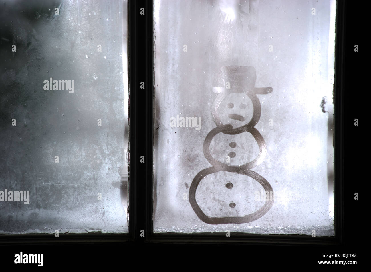 Snowman image on frosty window Stock Photo - Alamy
