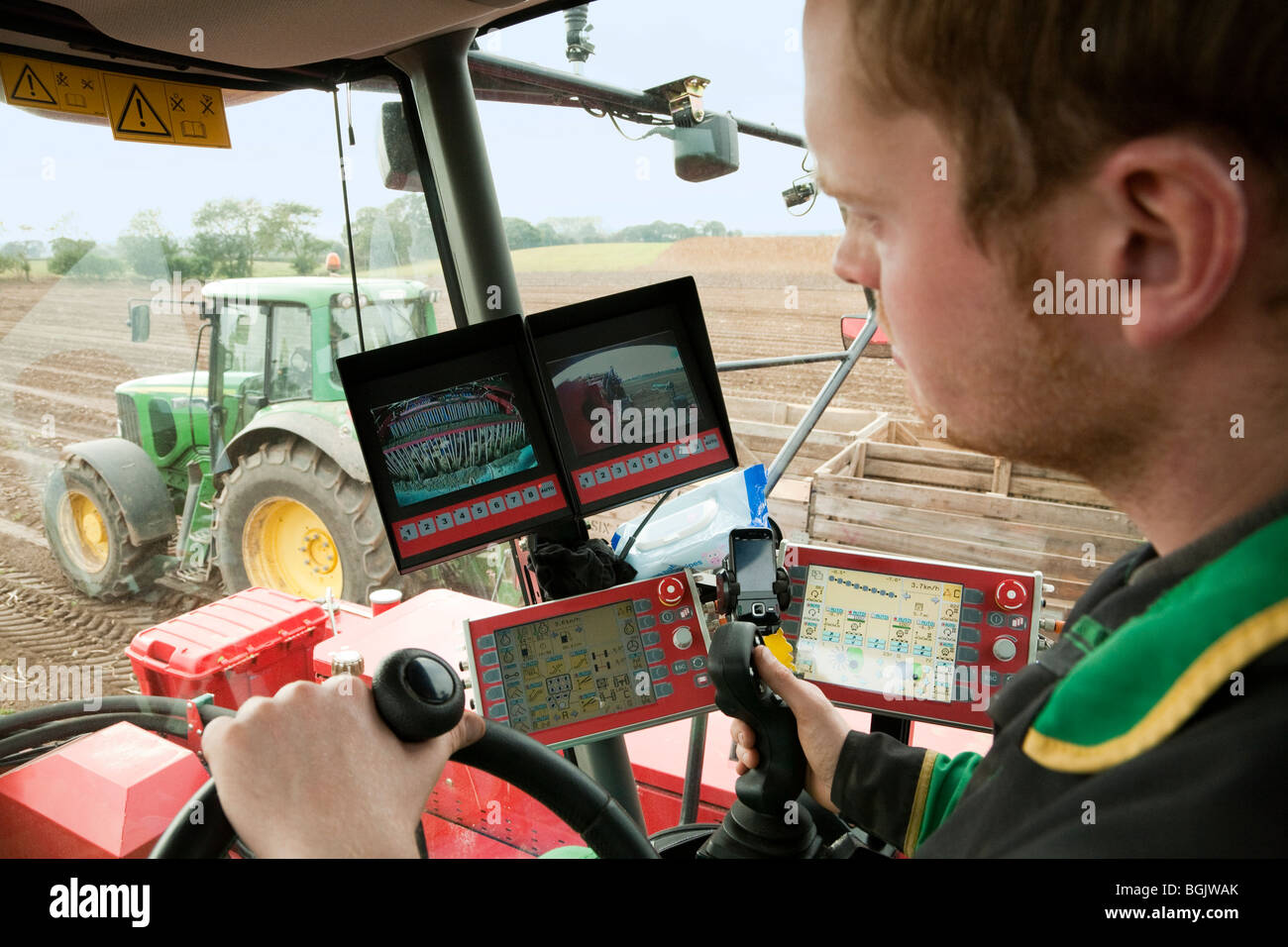 Cab interior of a potato harvester showing computer and monitor screens ...