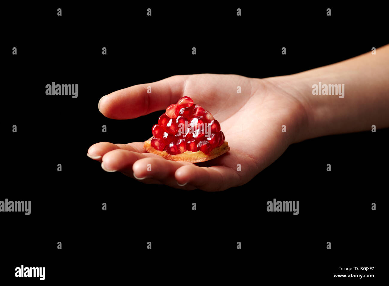 Hand holding pomegranate hi-res stock photography and images - Alamy