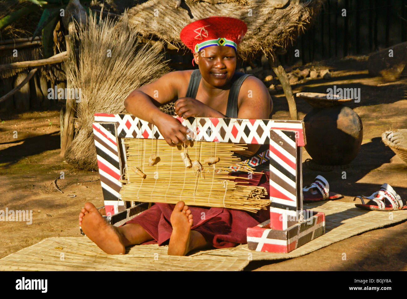 Zulu woman weaving reed mat, Shakaland, South Africa Stock Photo - Alamy