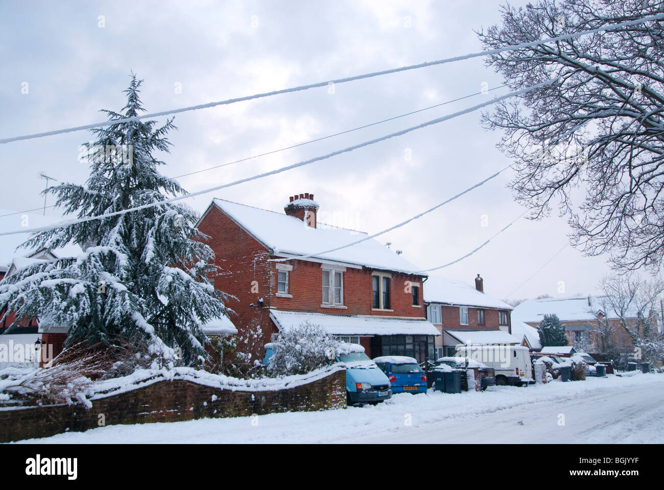 domestic house and snow covered telephone lines on urban street. Major ...