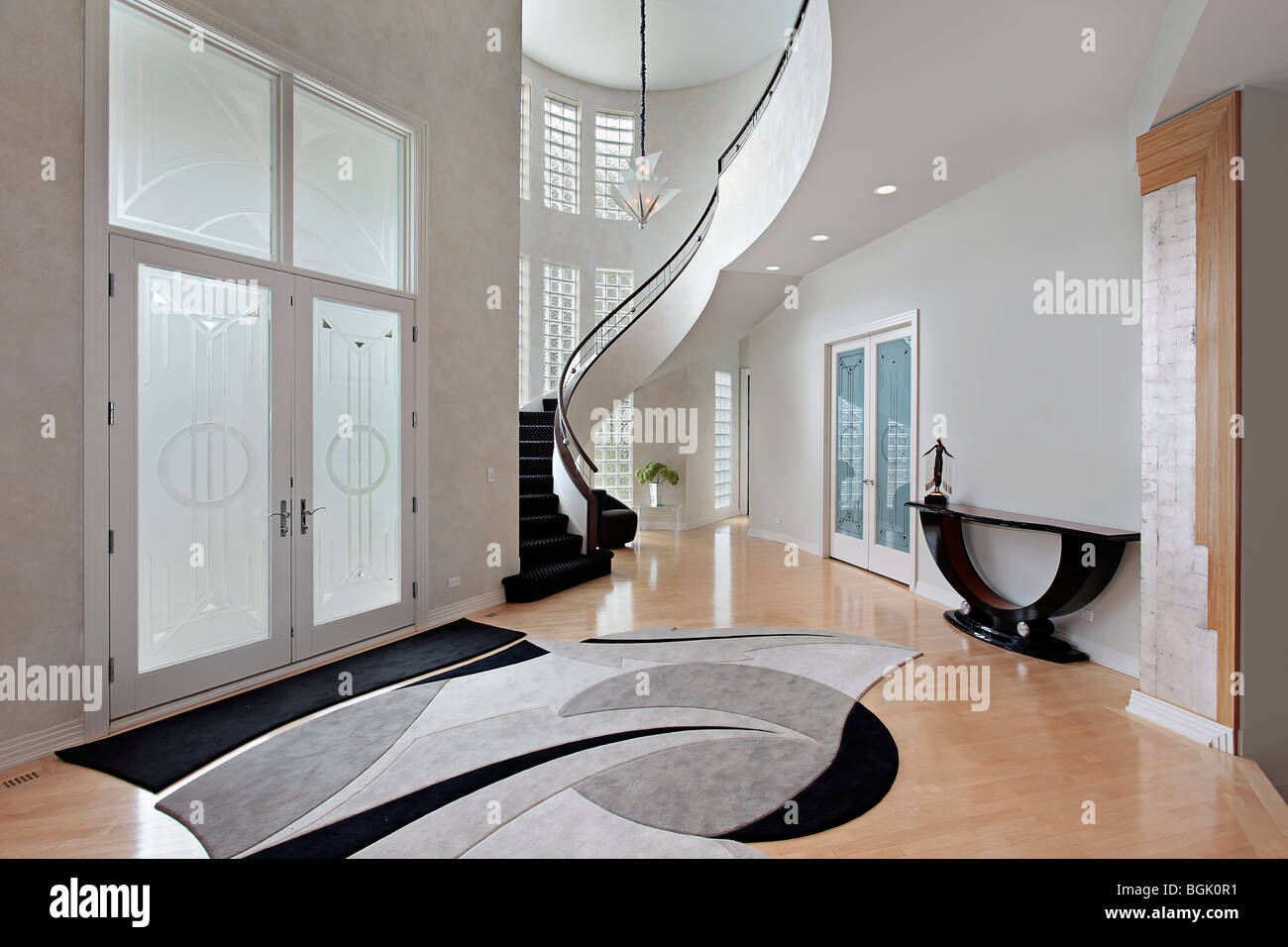 Foyer in modern home with glass doors Stock Photo - Alamy
