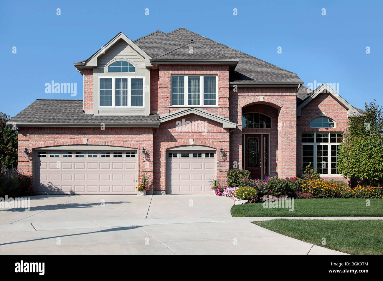 Brick home in suburbs with arched entry Stock Photo - Alamy
