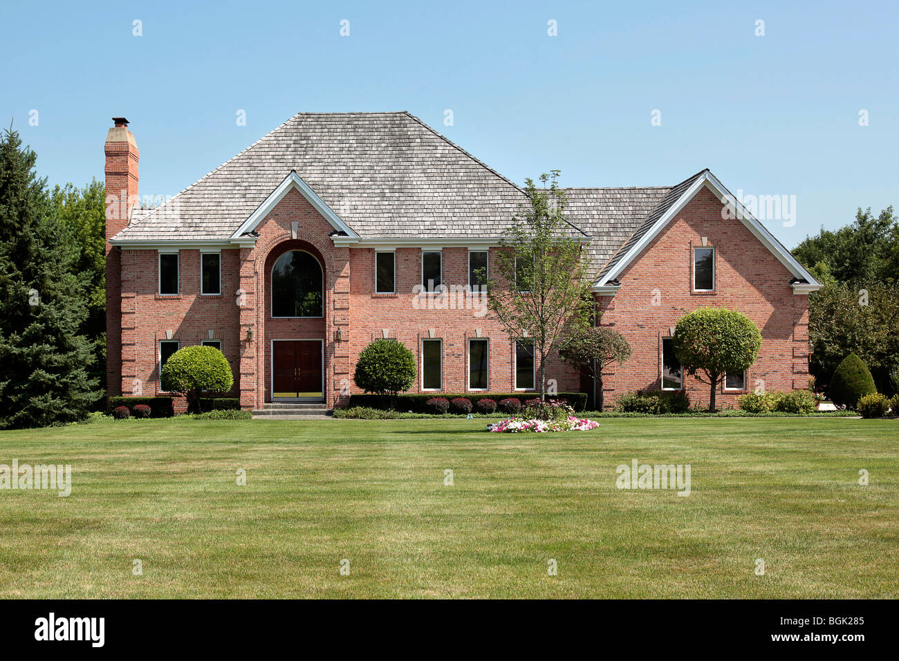 Luxury brick home in suburbs with arched entry Stock Photo - Alamy
