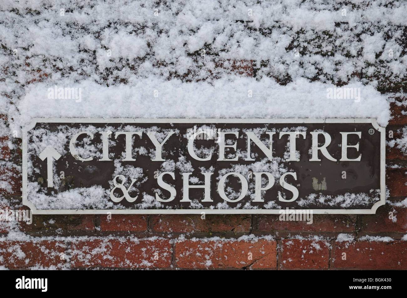 Sign reading CITY CENTRE AND SHOPS covered with snow and ice Lichfield ...