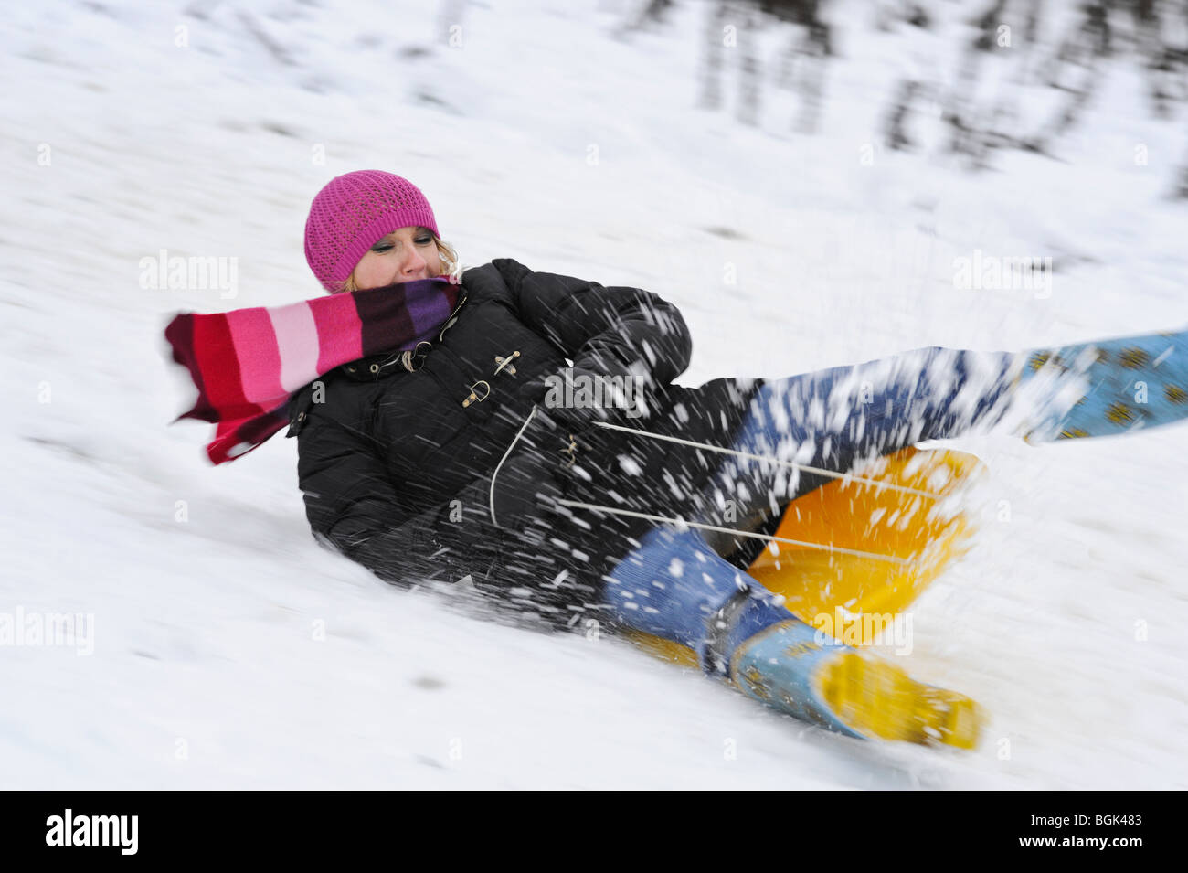 Woman having fun on sledge Stock Photo - Alamy