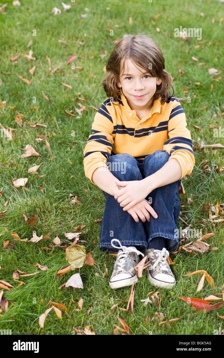 boy sitting on grass Stock Photo - Alamy