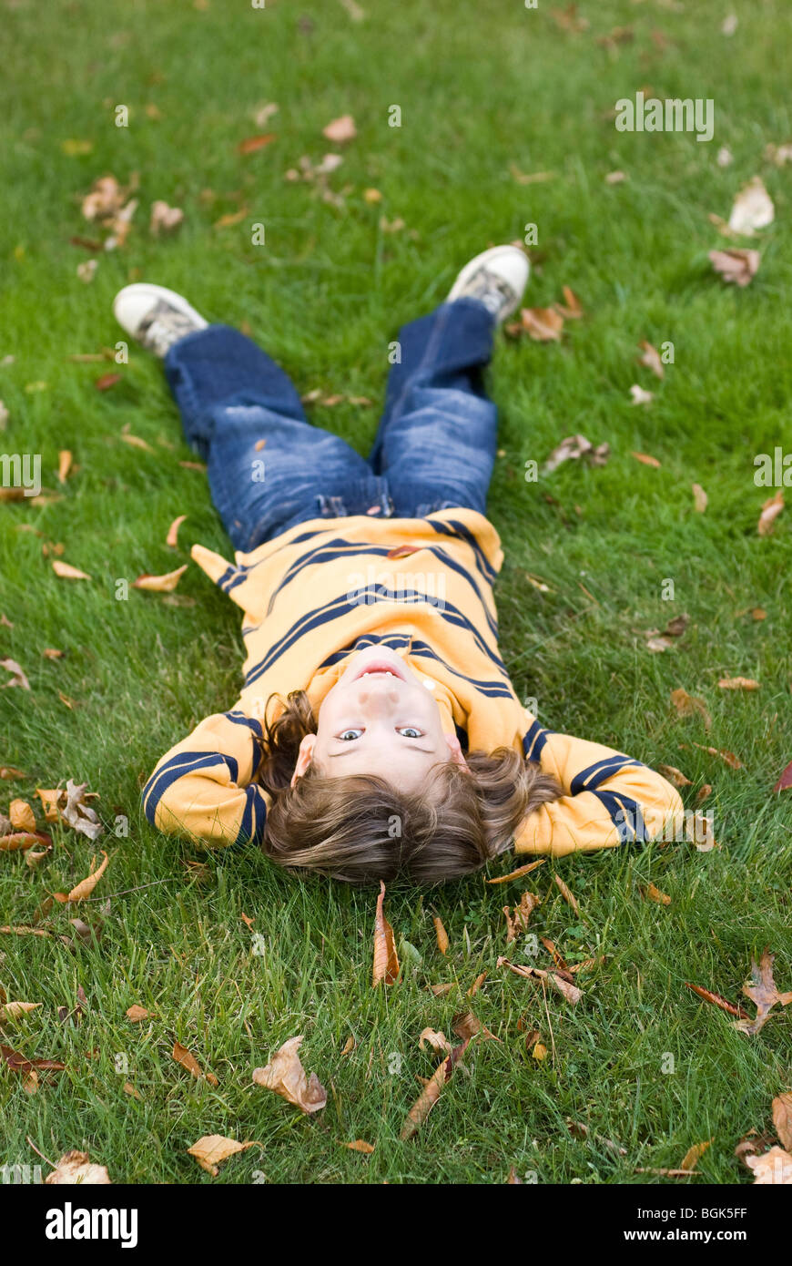 boy lying on grass Stock Photo - Alamy