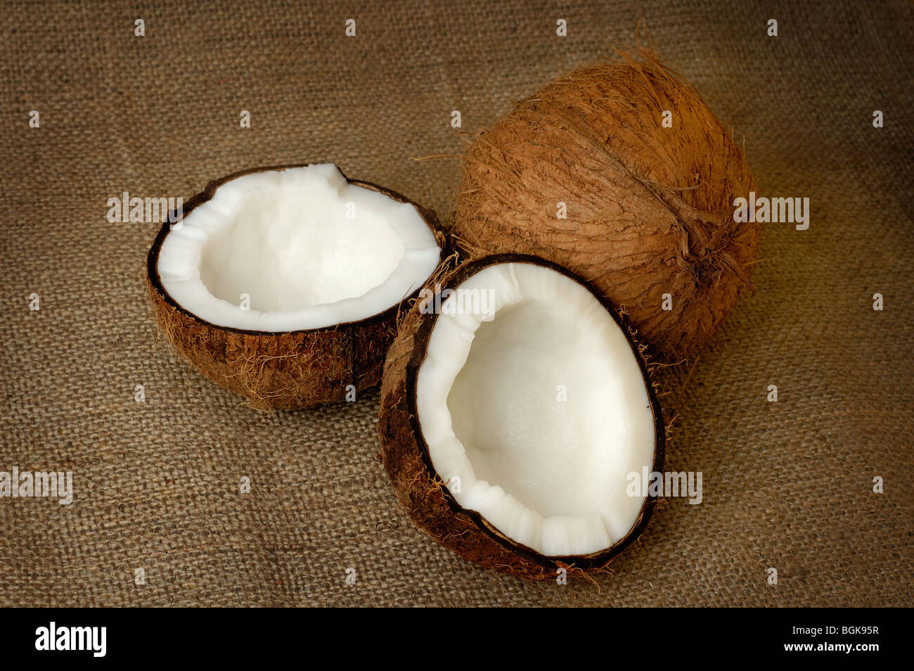 Two coconuts on a table healthy food still-life Stock Photo - Alamy