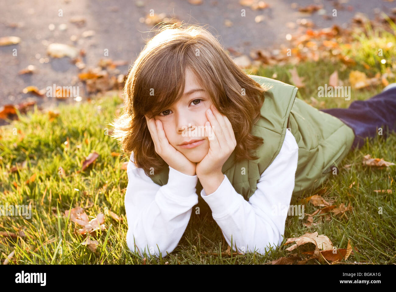 boy lying in grass Stock Photo - Alamy