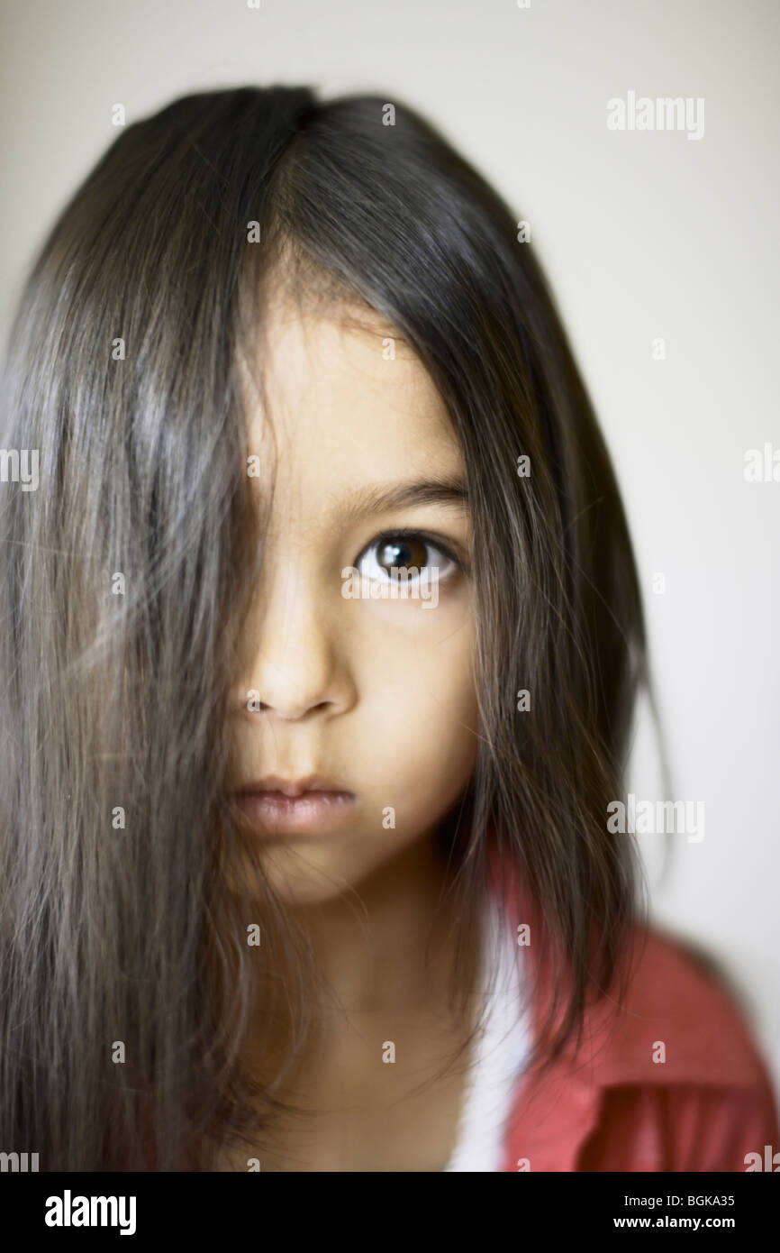Girl six years old with hair across face Stock Photo - Alamy