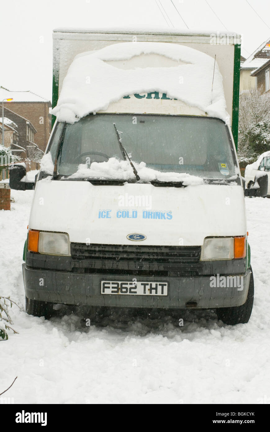 A snow covered white Ford Transit van advertising 'ICE COLD DRINKS ...