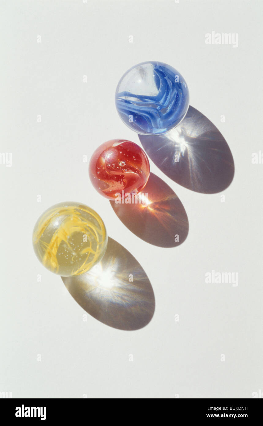 Three marbles on white background Stock Photo - Alamy