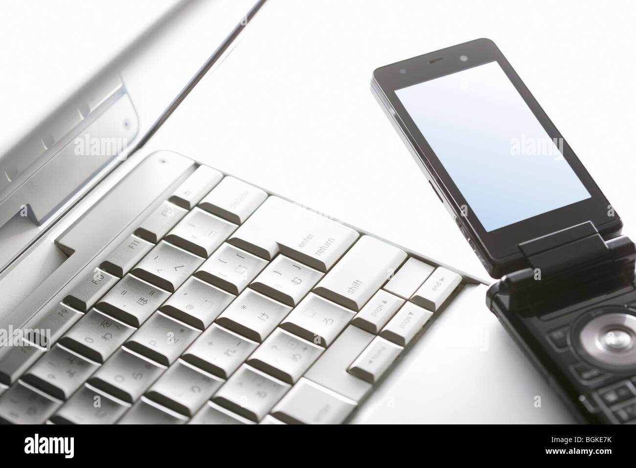 A mobile phone and a notebook PC Stock Photo - Alamy