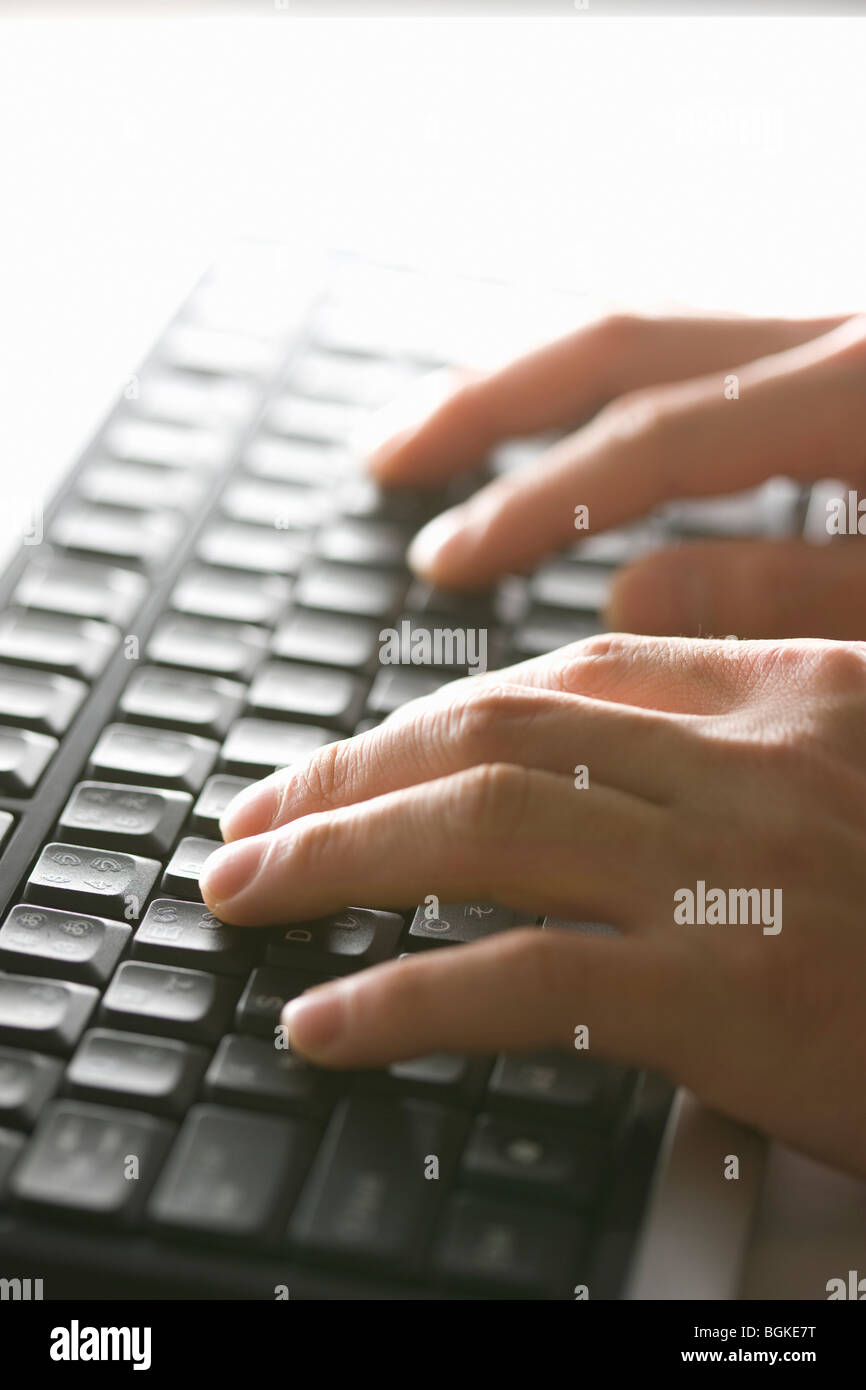 Person typing on keyboard Stock Photo - Alamy