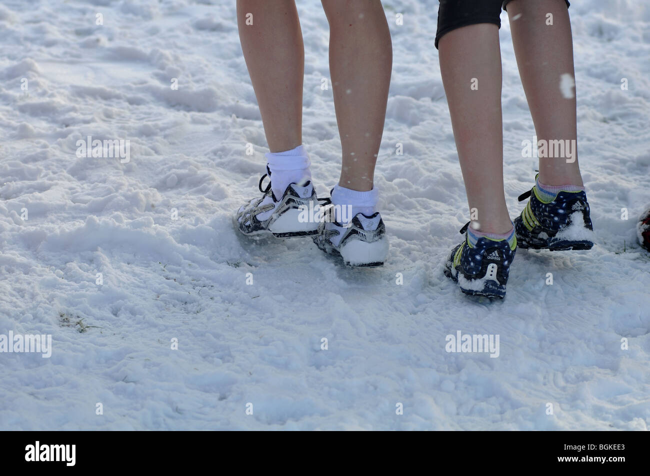 Teenage girls on start line of cross-country running race standing in ...