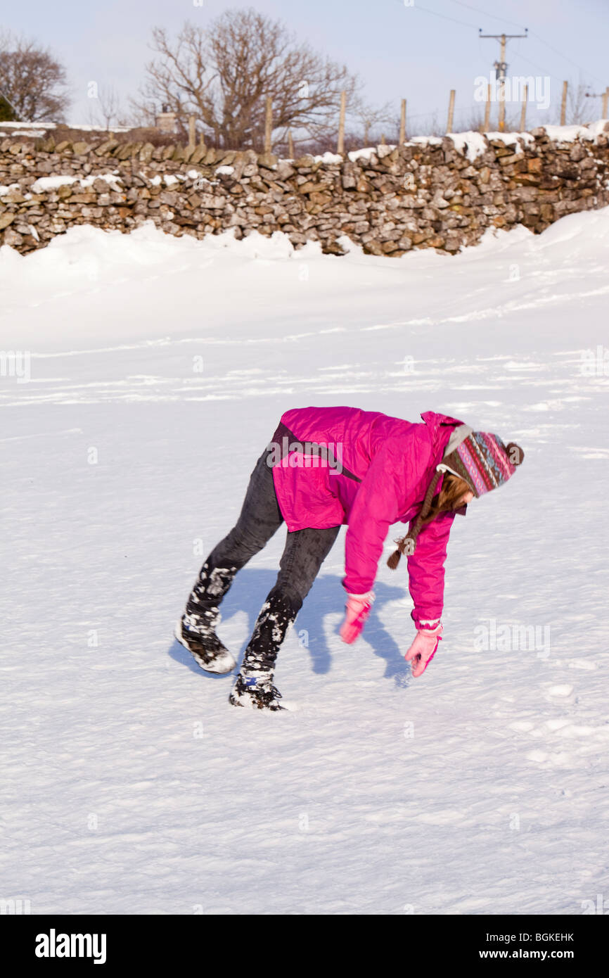 A young girl tripping up in the snow, Settle, Yorkshire Dales, UK Stock ...
