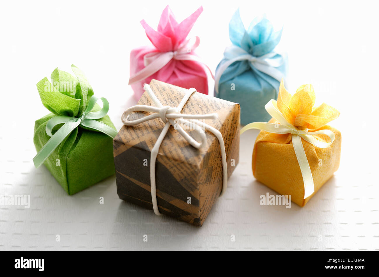 Small gift boxes wrapped in tissue paper Stock Photo - Alamy
