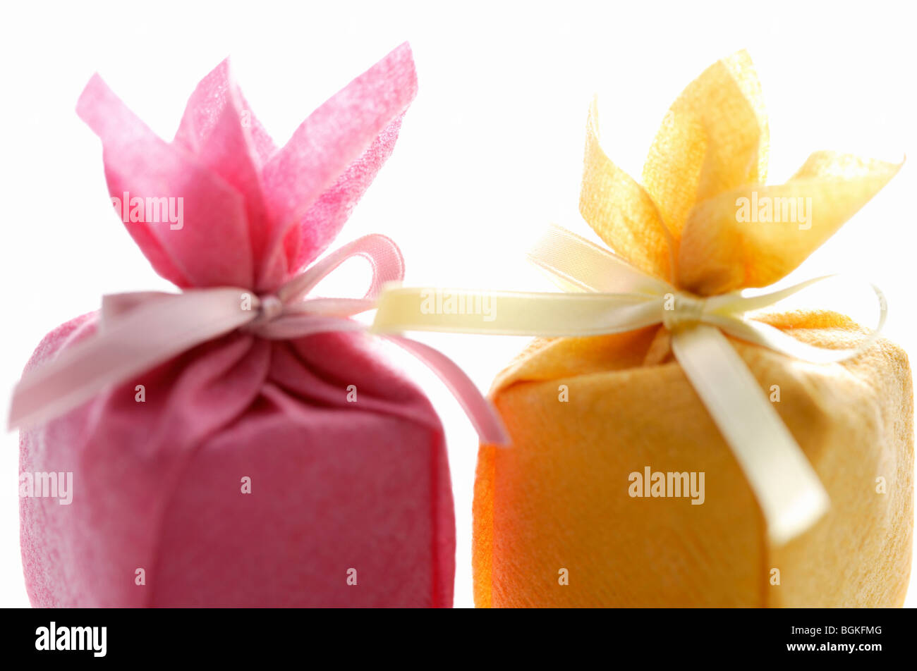 Small gift boxes wrapped in tissue paper Stock Photo - Alamy