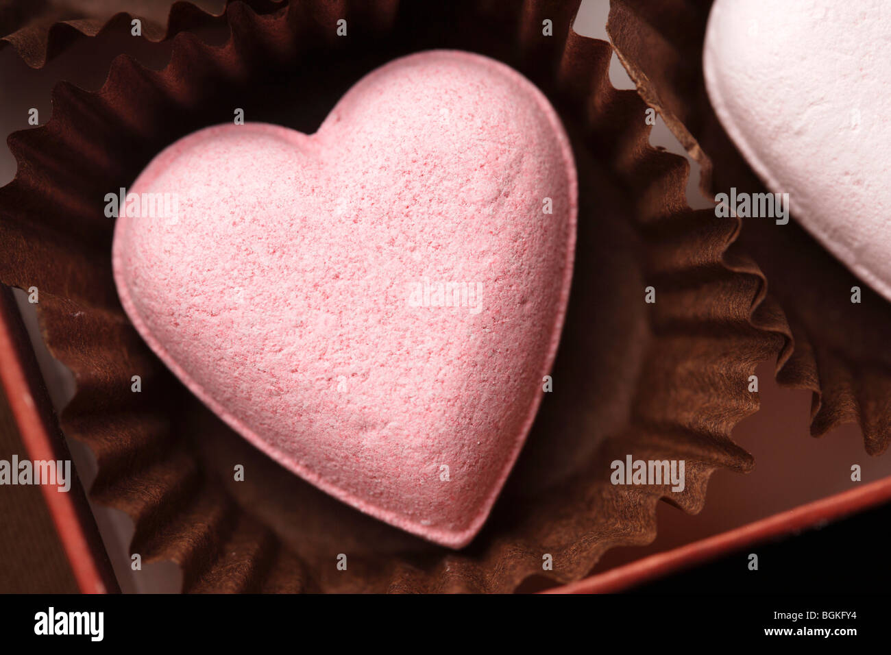 Pink candy heart in a cupcake wrapper Stock Photo - Alamy