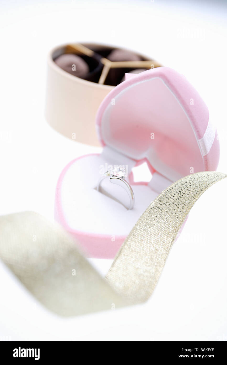 Diamond ring in a heart shaped box and a box of chocolates Stock Photo ...