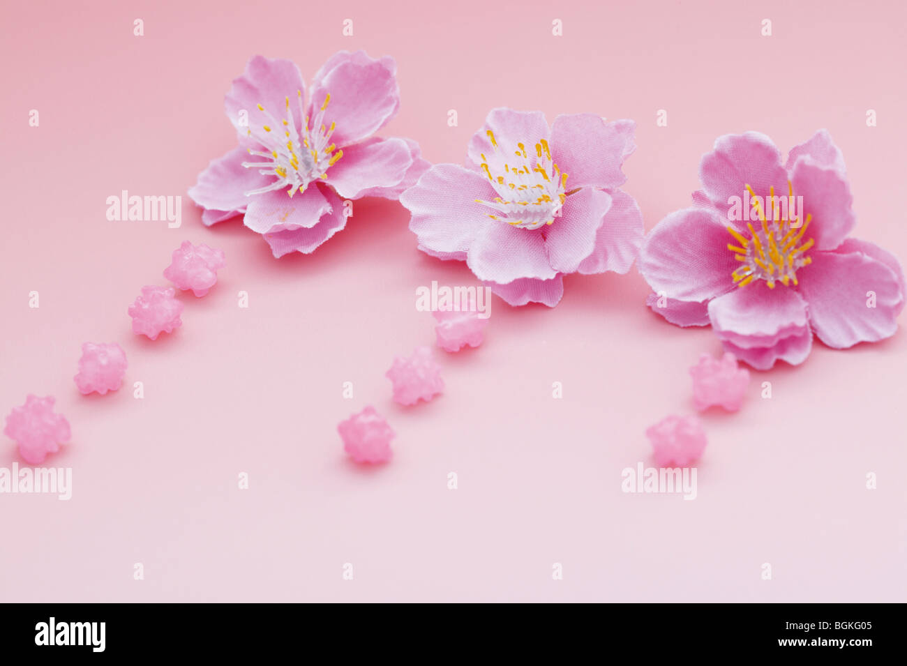 Pink flowers and kompeito candy Stock Photo - Alamy