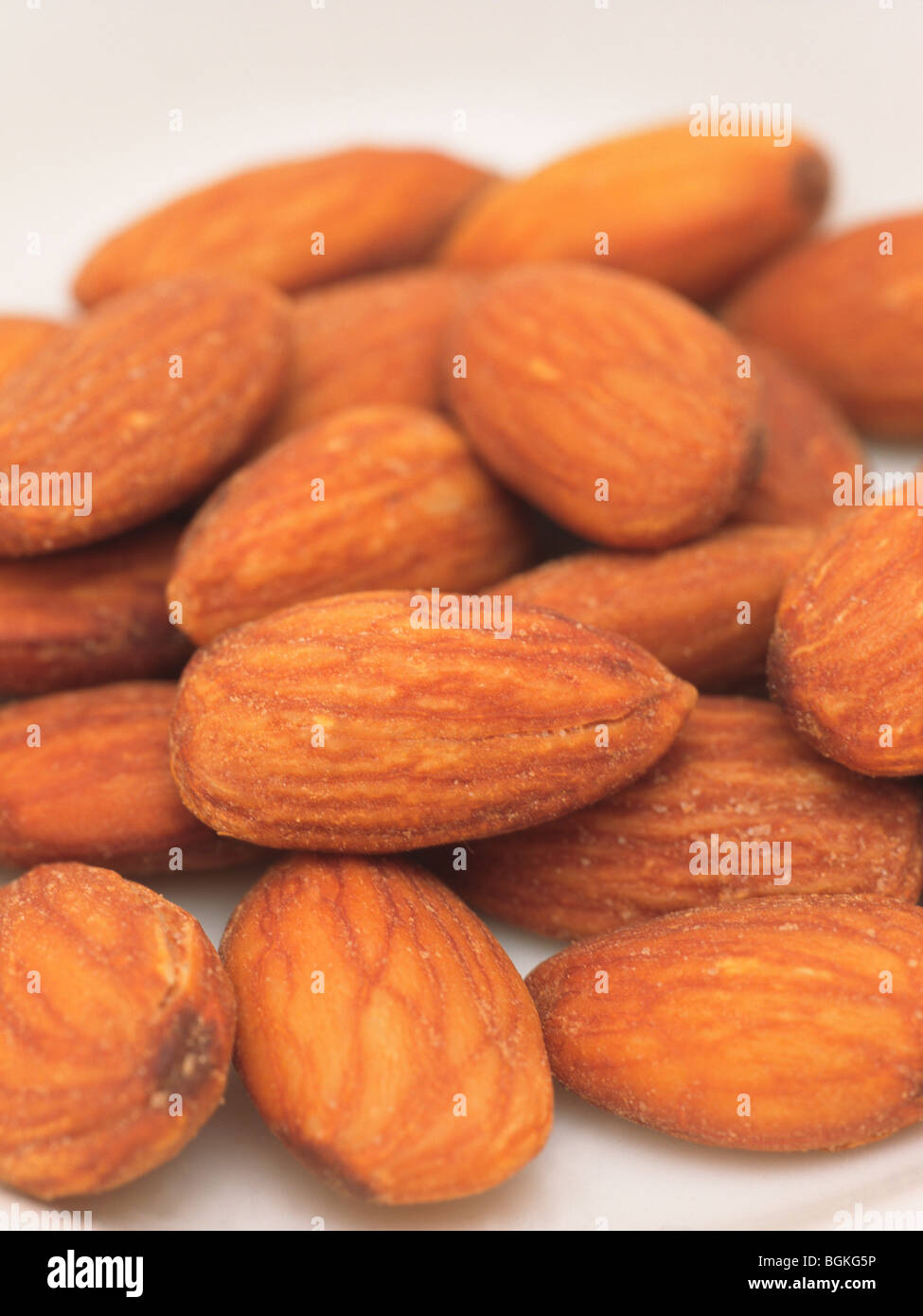 Almonds close up white background Stock Photo - Alamy