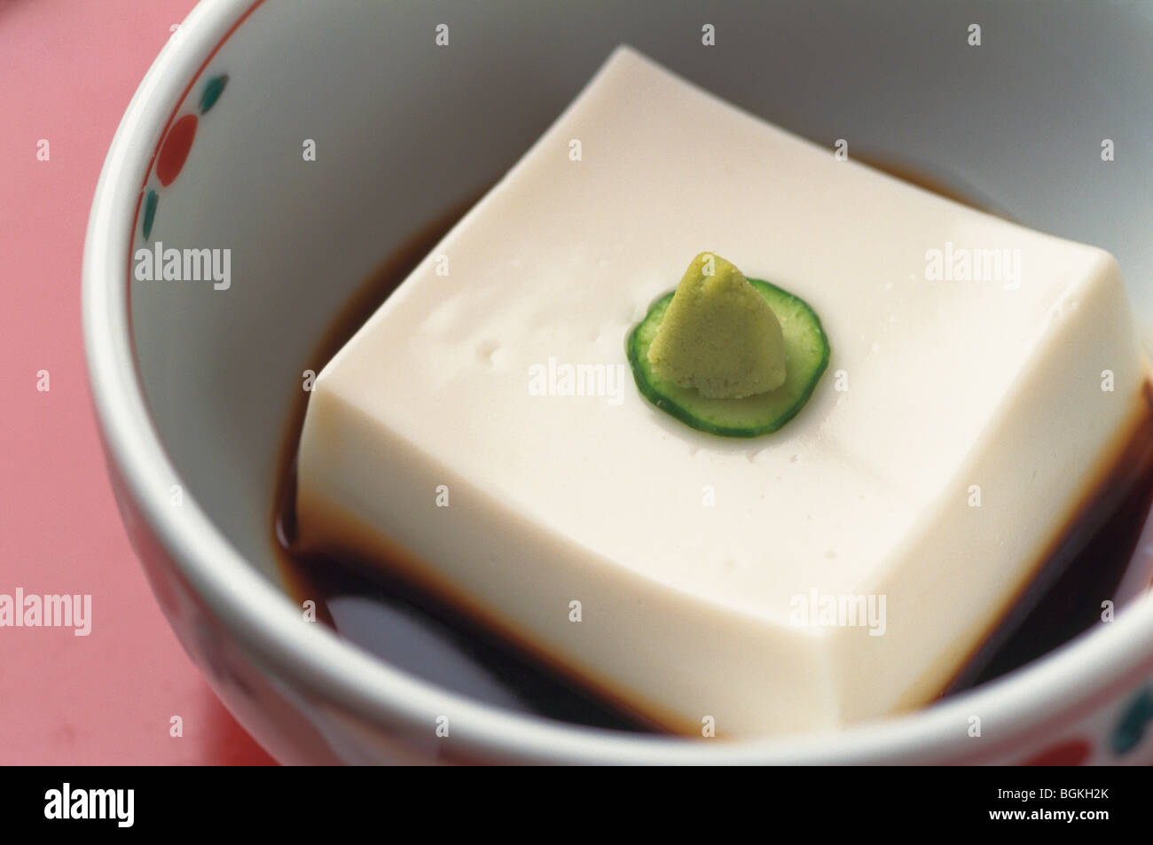 Bowl of sesame Tofu close up red background Stock Photo - Alamy