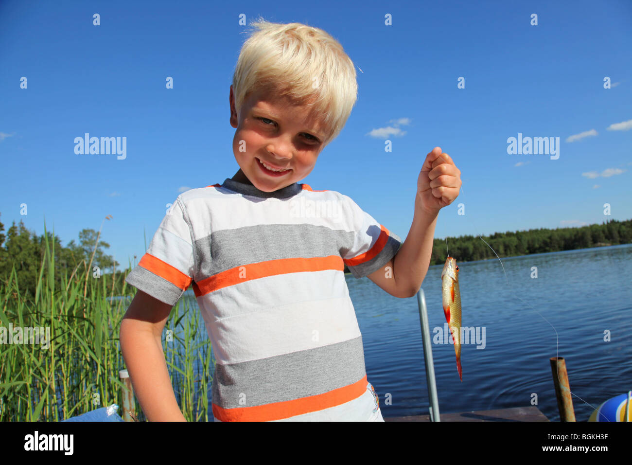 proud young boy showing his fish Stock Photo - Alamy