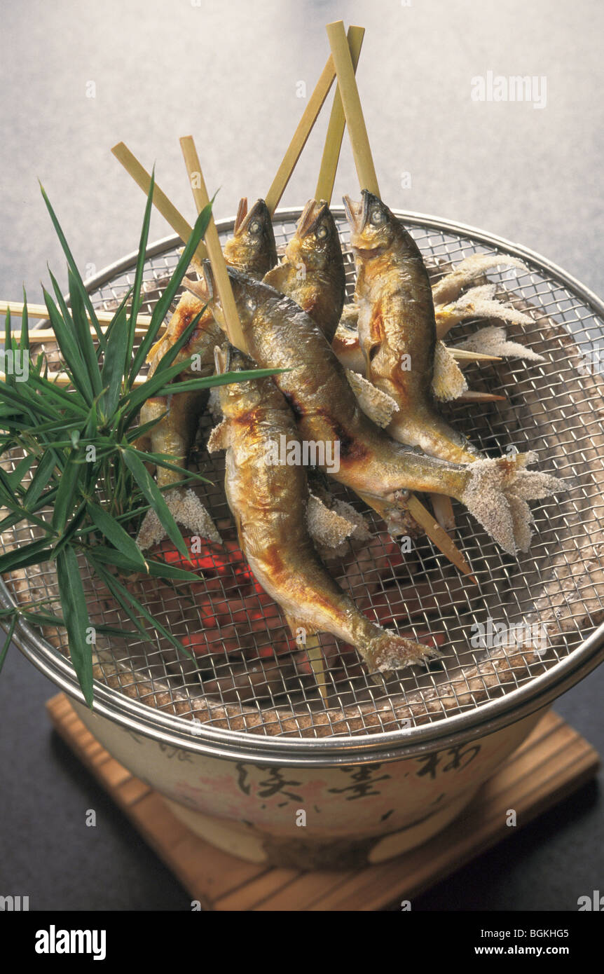 Sweetfish grilled with salt on a charcoal brazier Stock Photo - Alamy