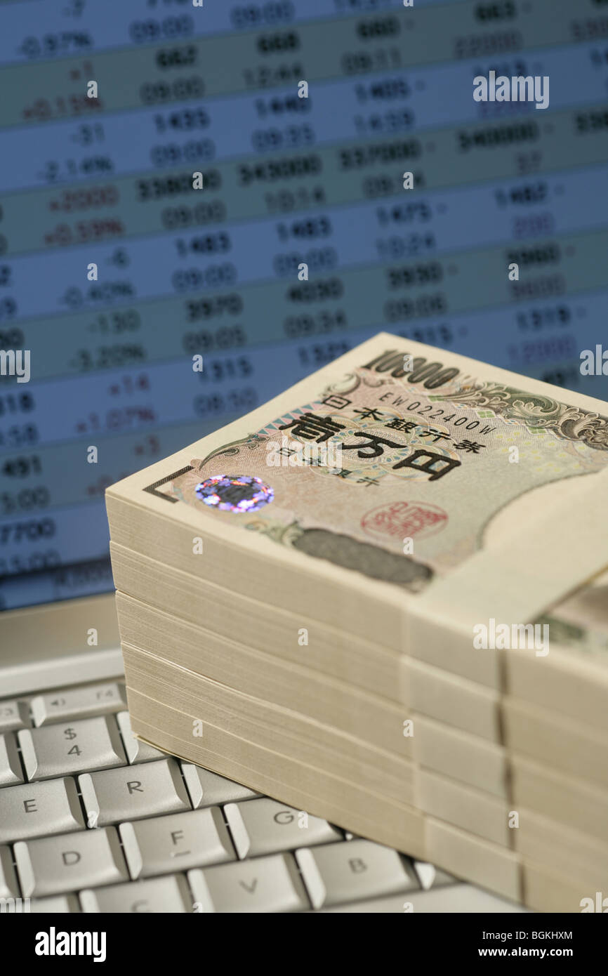 Bundles of 10 000 yen notes on a computer keyboard Stock Photo - Alamy