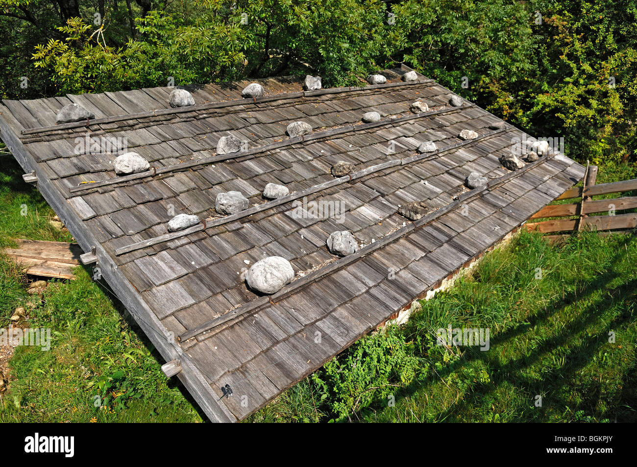 Upper Bavarian shingled roof of a barn weighed down with stones ...