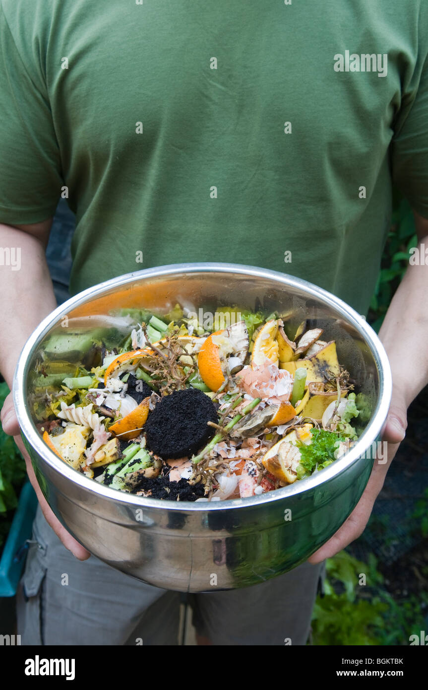 Man holding bowl of kitchen compost Stock Photo - Alamy