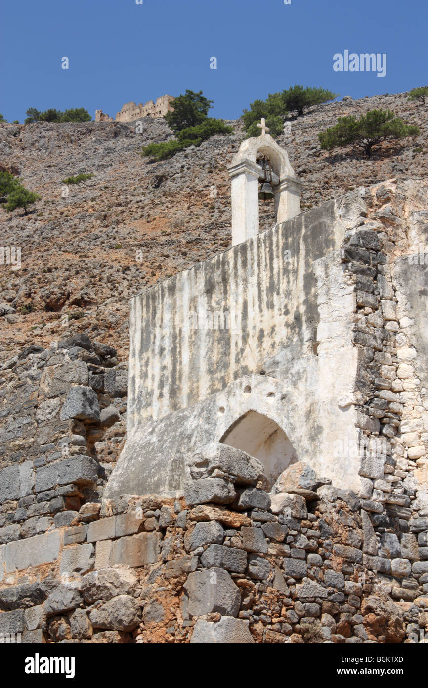 Church with ruined castle above at the end of the Samaria Gorge Stock ...