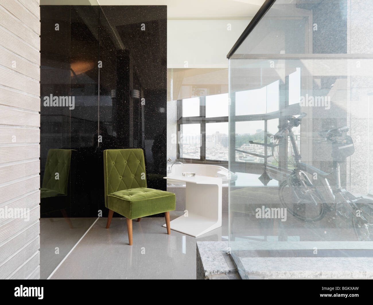 Green velvet char in corner Stock Photo - Alamy