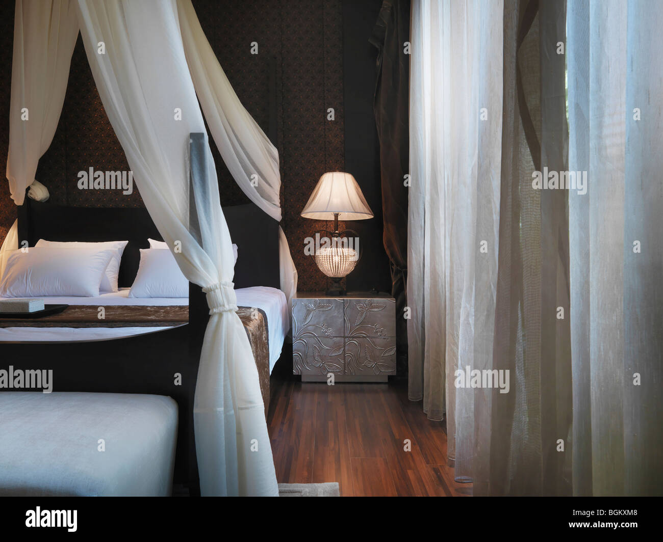 Mosquito net above bed Stock Photo - Alamy