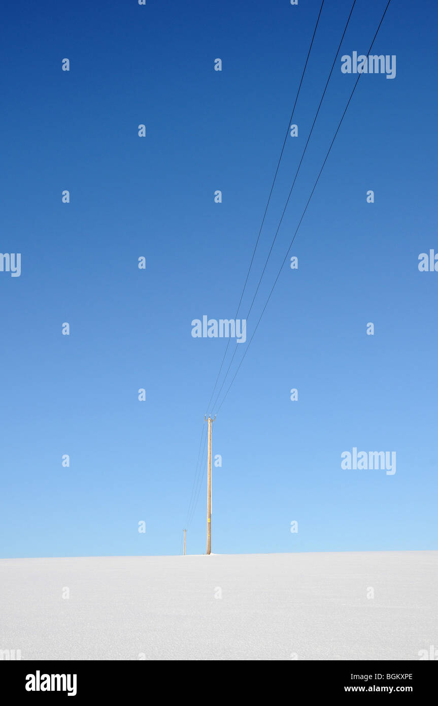power lines and poles over a snow covered field Stock Photo - Alamy