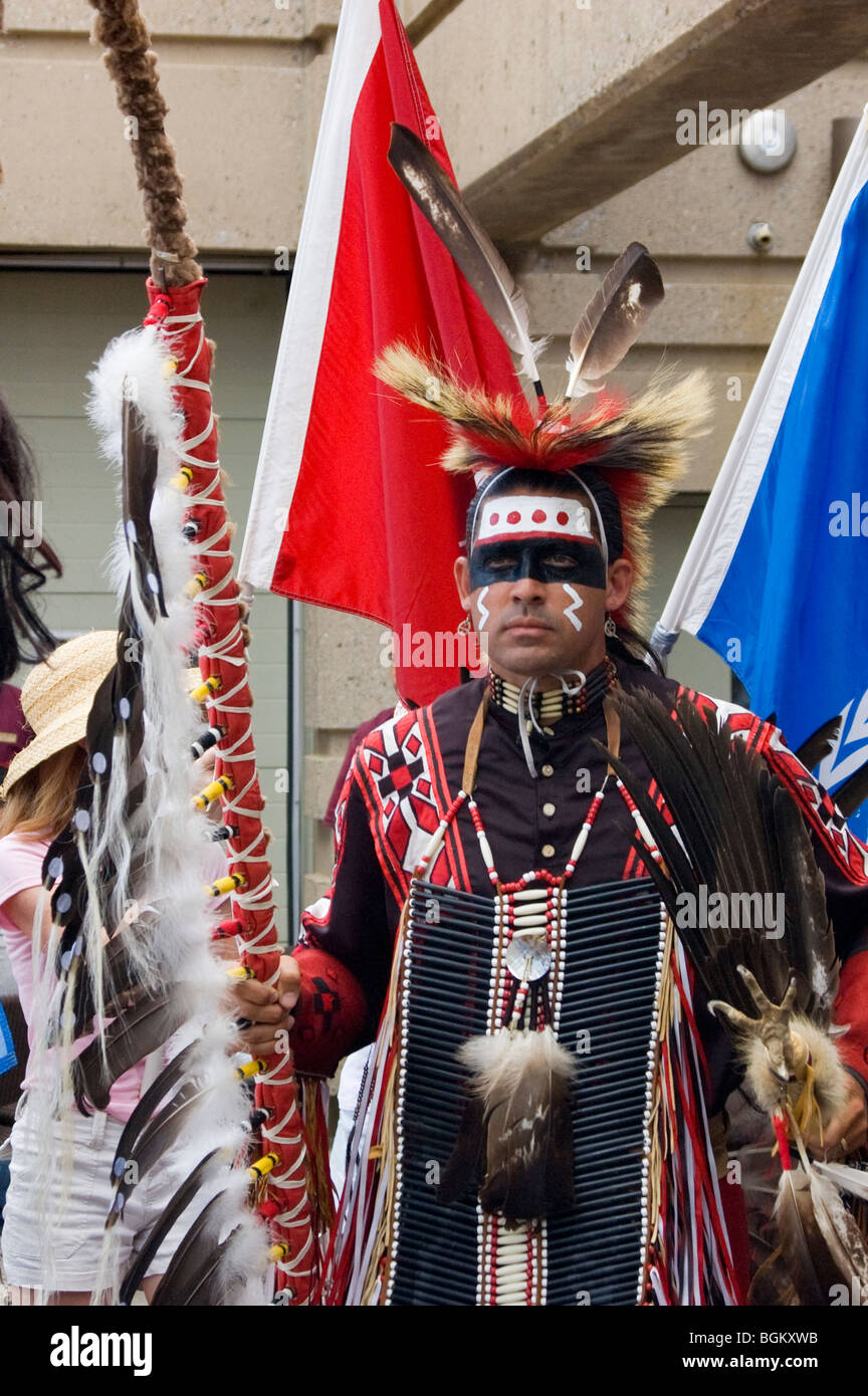 First Nations Blackfeet man with painted face demonstrates traditional ...