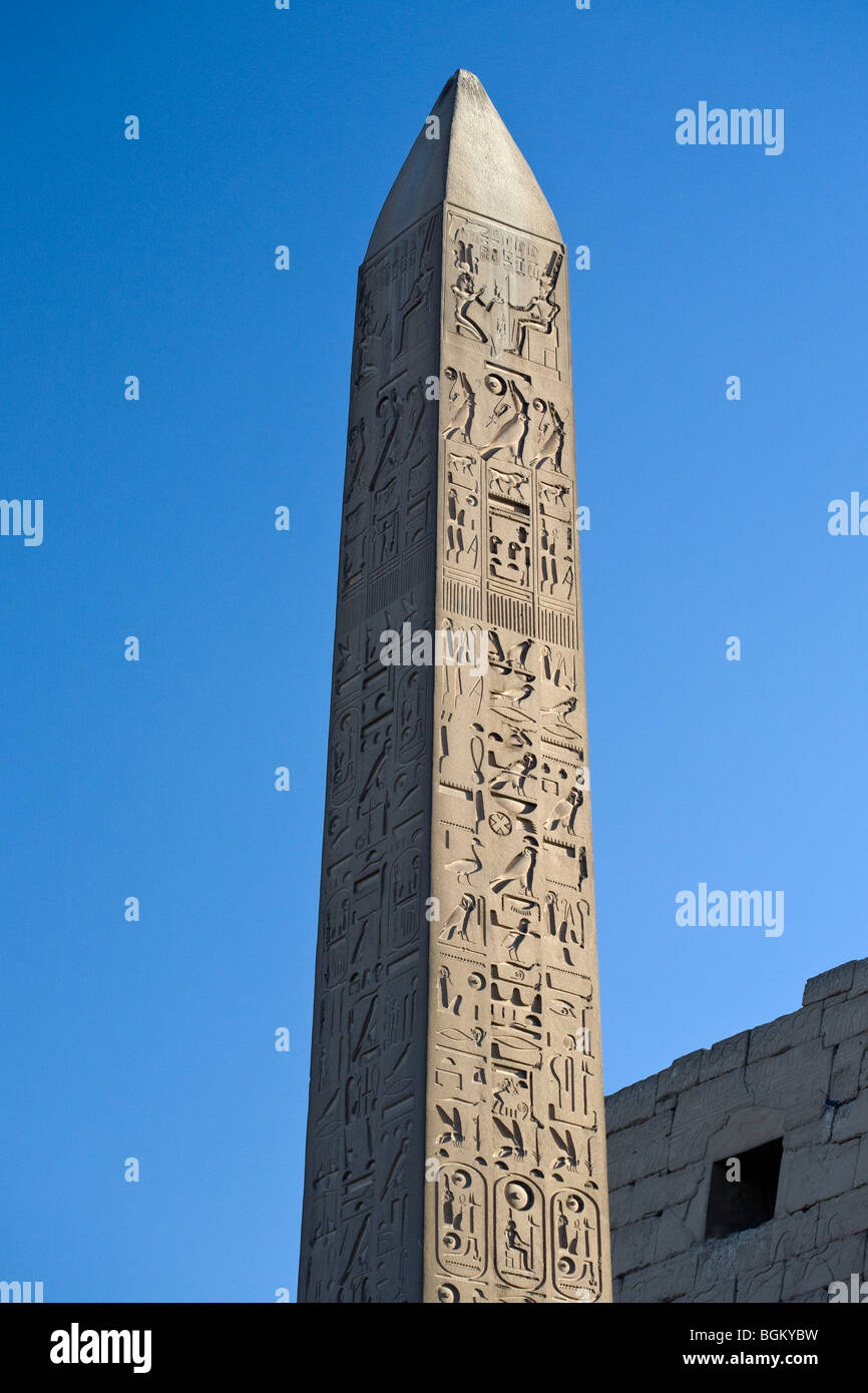 The red granite Obelisk of Ramesses II in front of the First Pylon at Luxor Temple, Luxor, Egypt ...