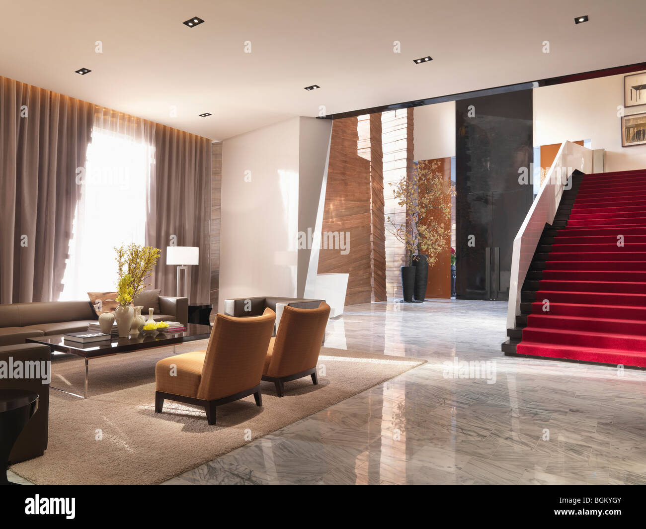 Sitting area and grand red staircase in modern interior Stock Photo - Alamy