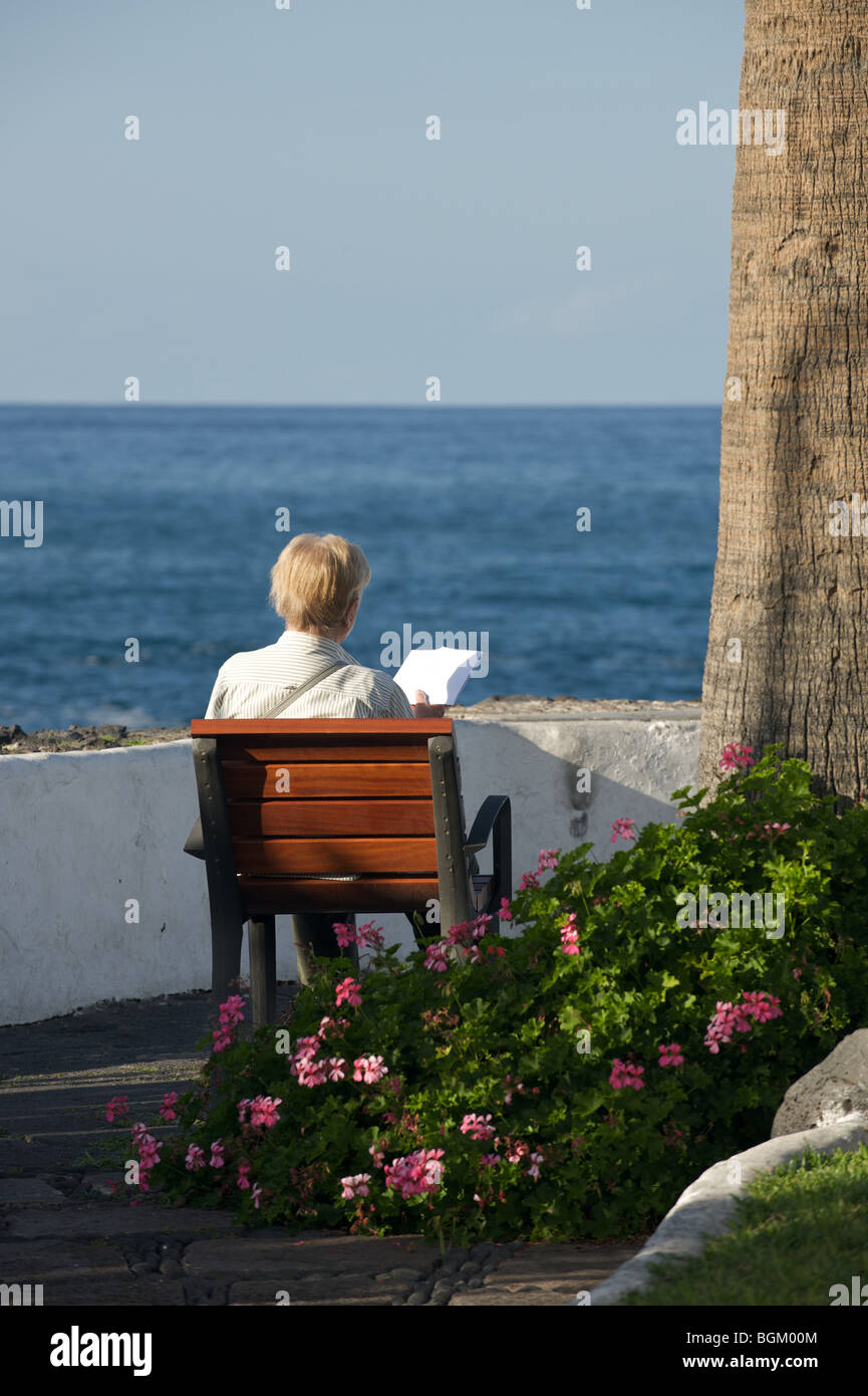 Woman reading her book near the Atlentic ocean, Tenerife Stock Photo ...