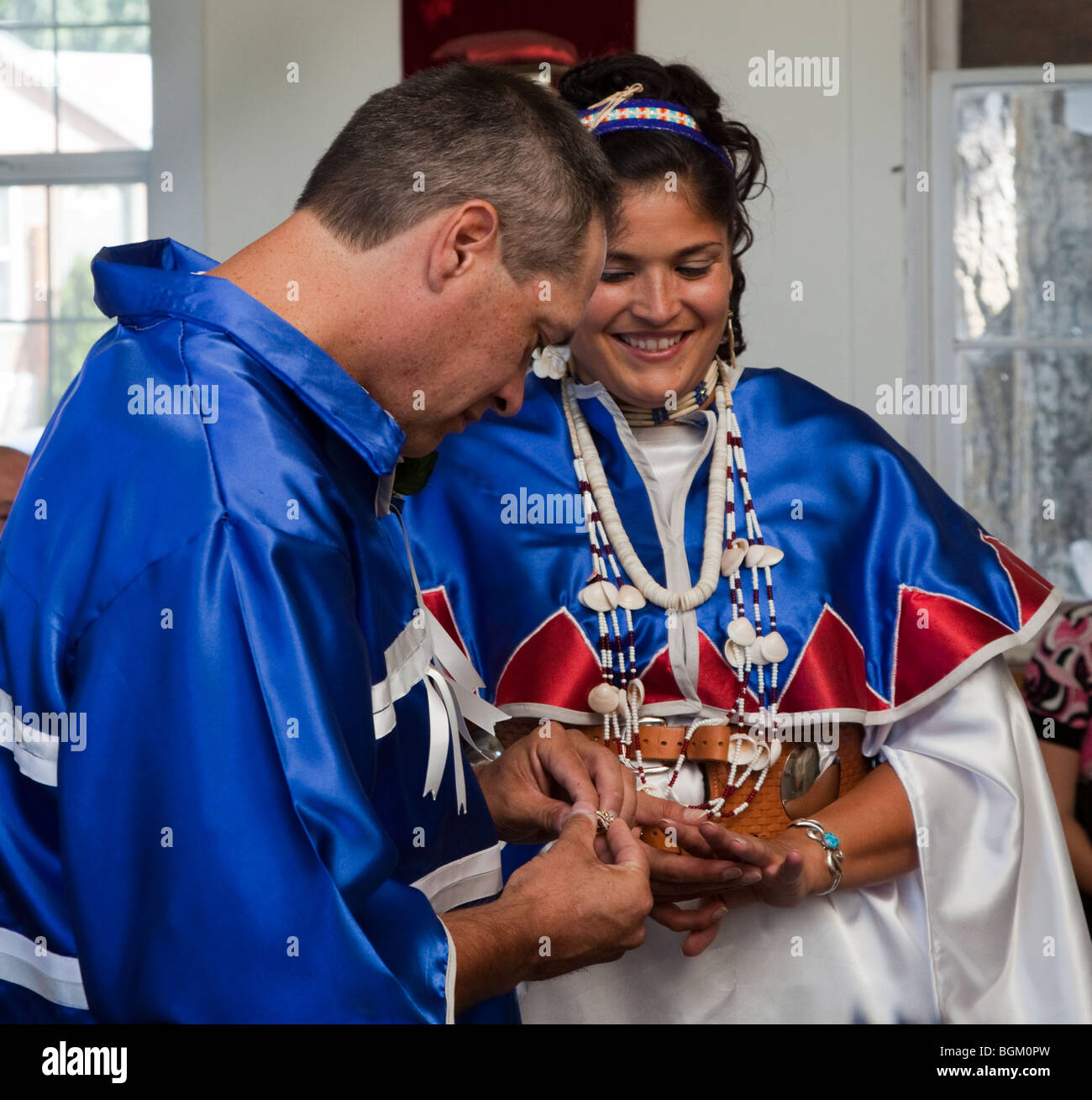 Native American bride and groom exchange rings during wedding ceremony ...
