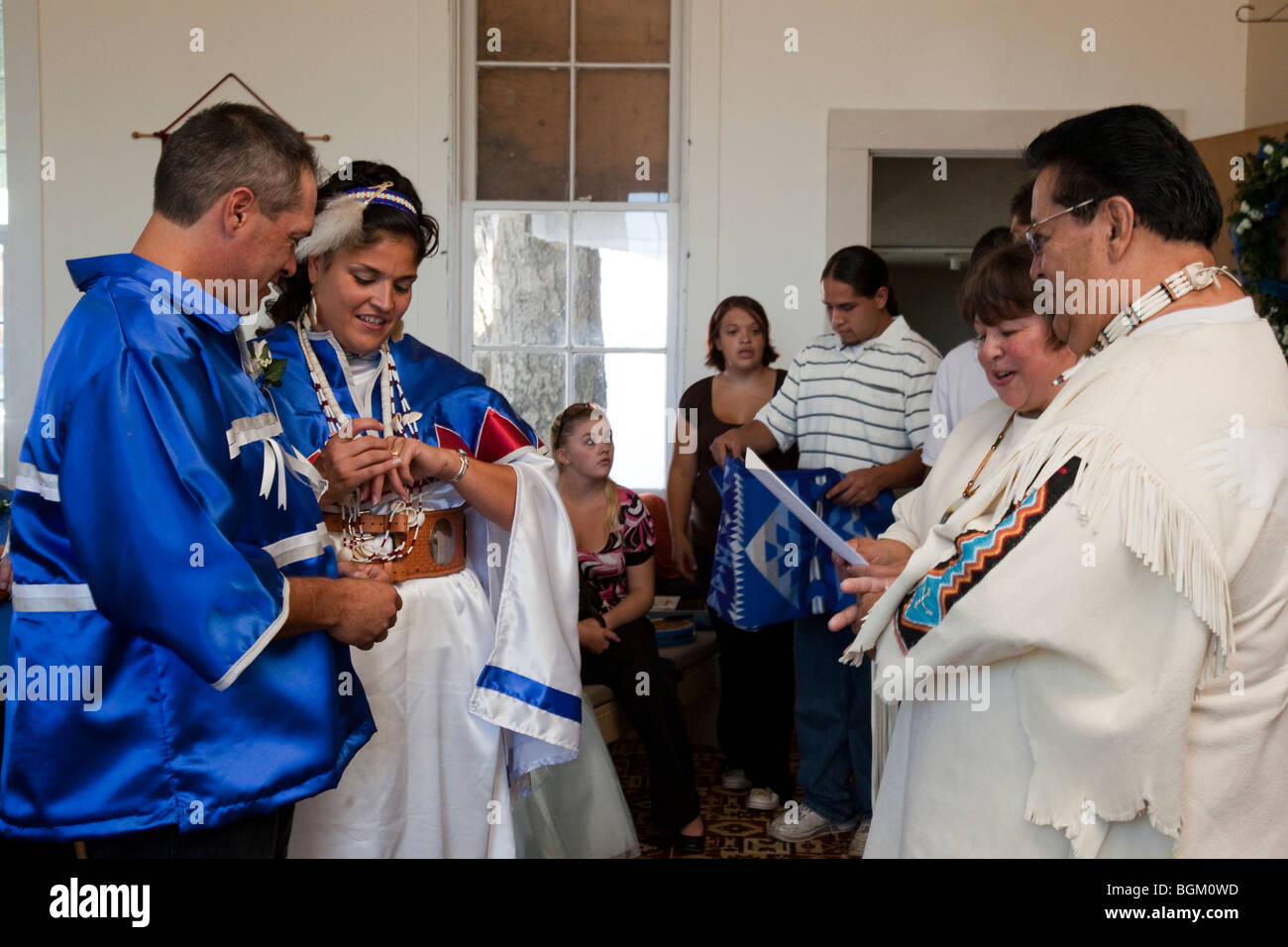 Native American bride and groom exchange rings during wedding ceremony ...