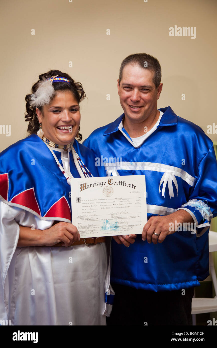 Native American bride and groom hold up their marriage certificate ...
